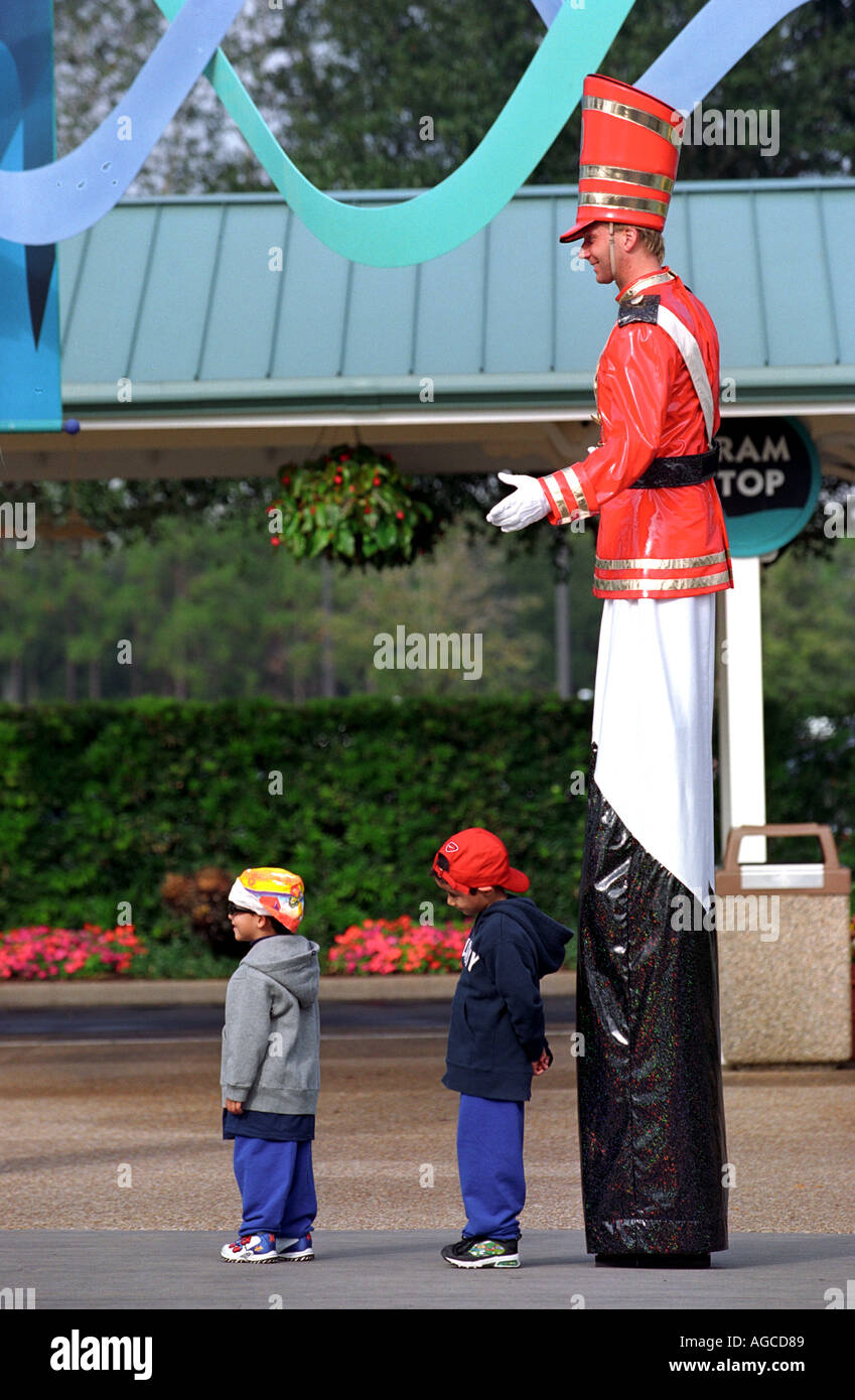 Two children pose with a man on stilts at SeaWorld in Orlando Florida ...