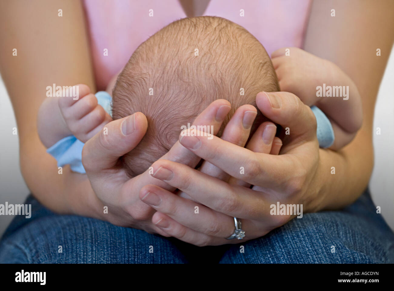 Top of head view of mother holding lying infant Stock Photo - Alamy