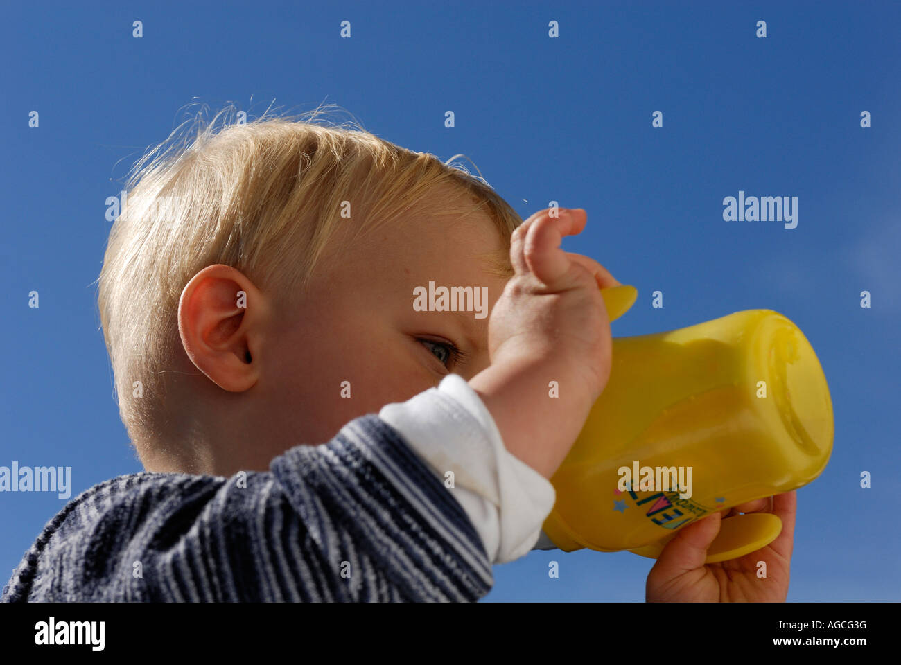Baby boy drinking tea from bottle Stock Photo - Alamy