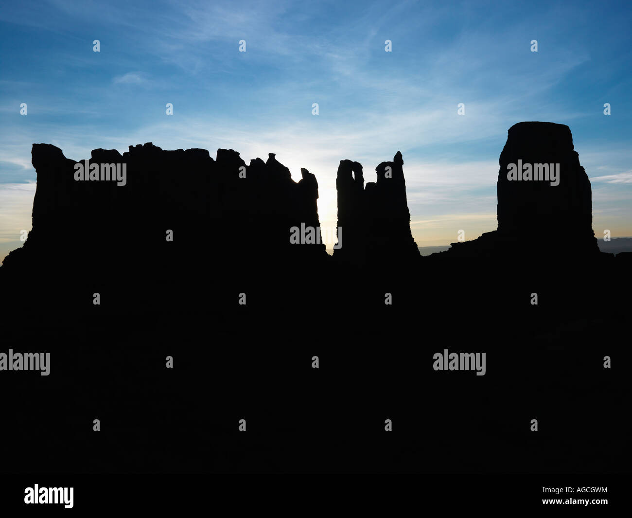 Sandstone mesas and buttes silhouetted in Monument Valley Stock Photo ...