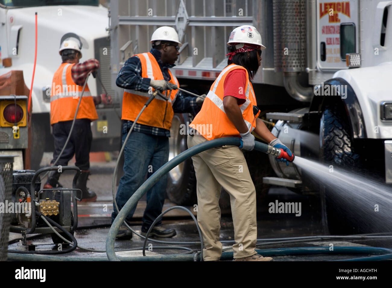 Freedom Tower construction workers wash dust and dirt off trucks as ...