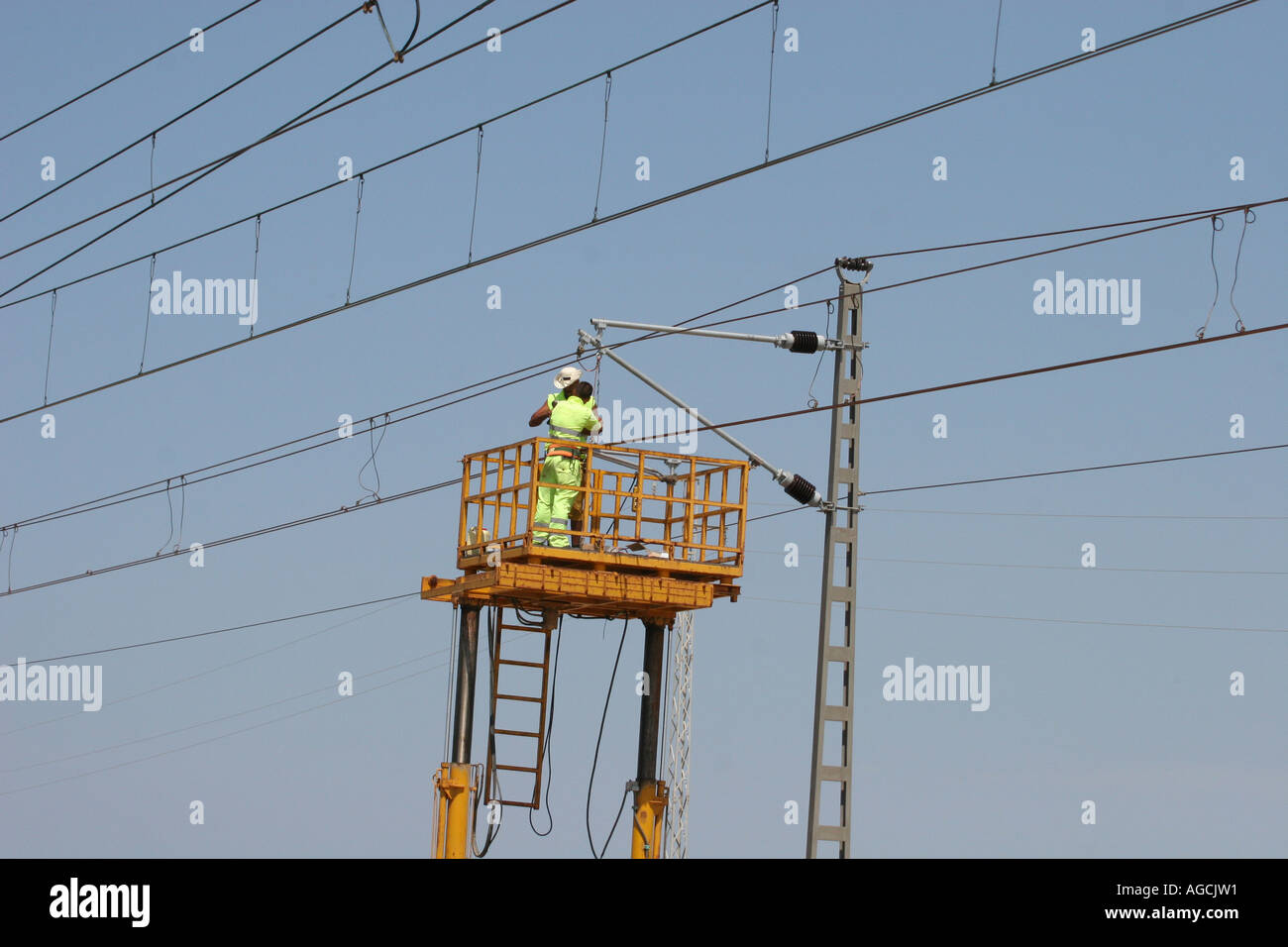 Rail workers fixing cable Stock Photo - Alamy