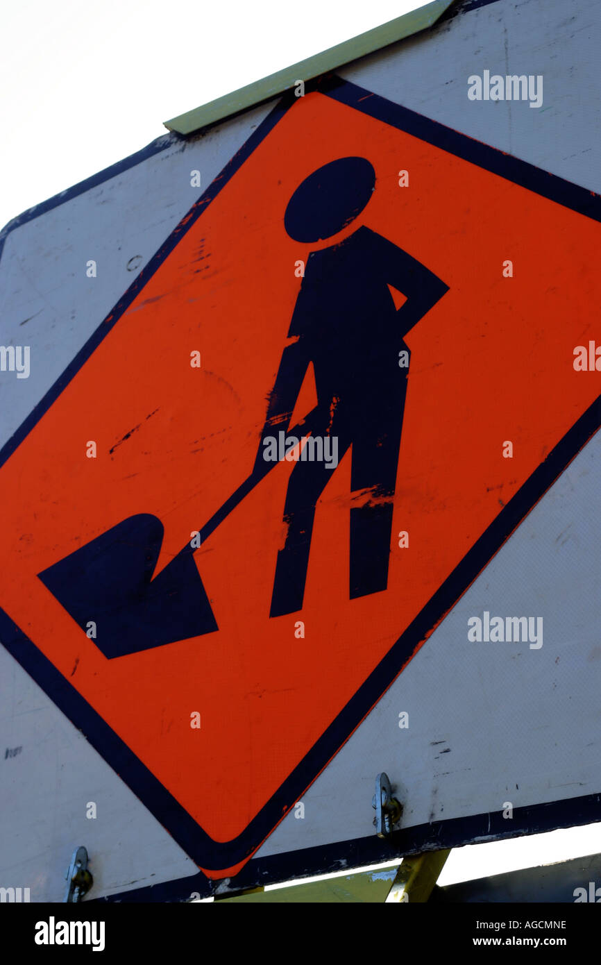 Man Digging road work sign. Men at work Stock Photo - Alamy