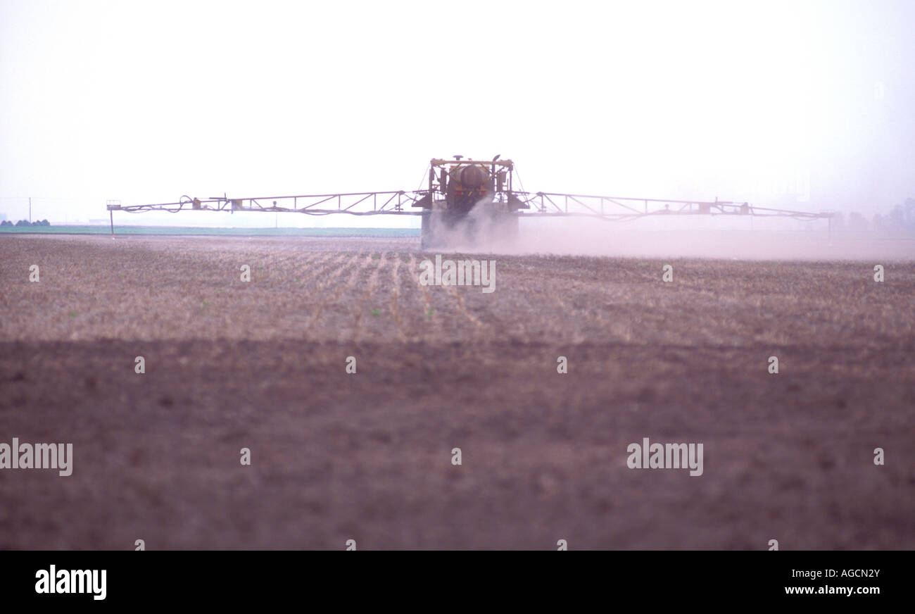 Spraying a farm field with herbicide or insecticide chemicals Stock ...