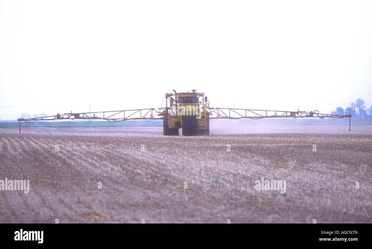 A sprayer in a farm field spraying herbicide and pesticide after spring ...