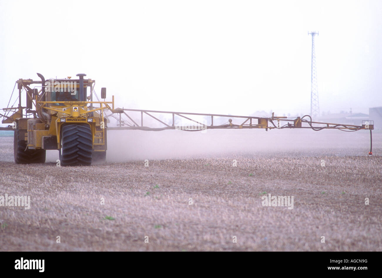 A sprayer in a farm field spraying herbicide and pesticide after spring ...
