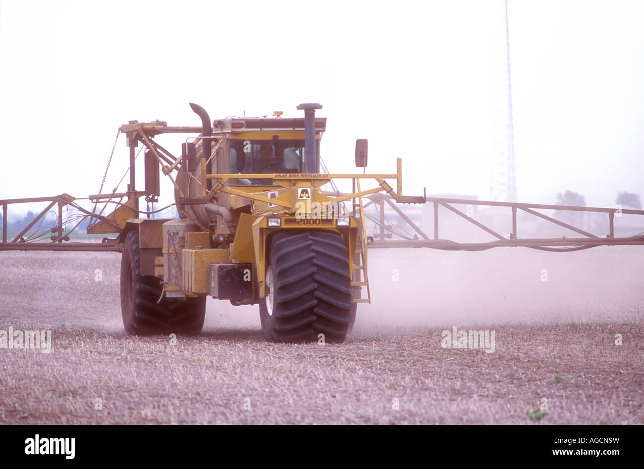 A sprayer in a farm field spraying herbicide and pesticide after spring ...