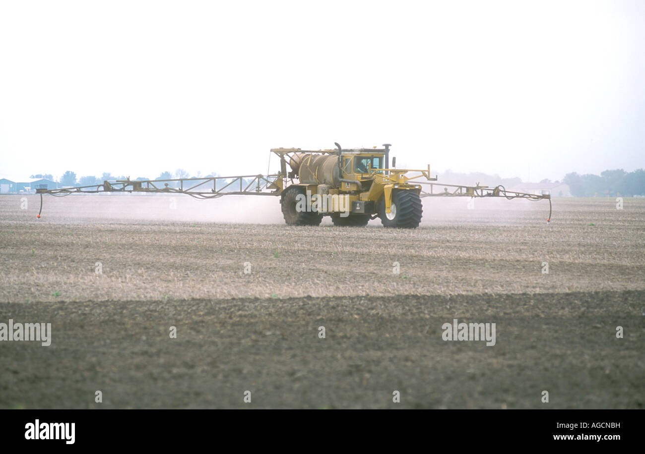 A sprayer in a farm field spraying herbicide and pesticide after spring ...