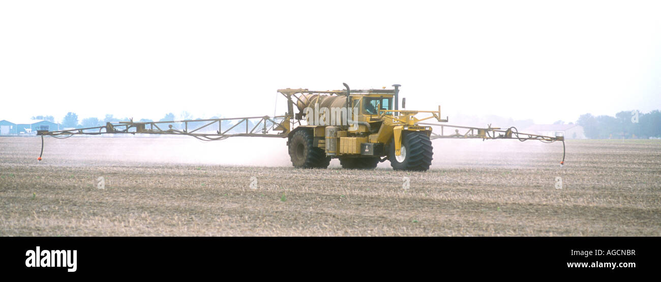 A sprayer in a farm field spraying herbicide and pesticide after spring ...