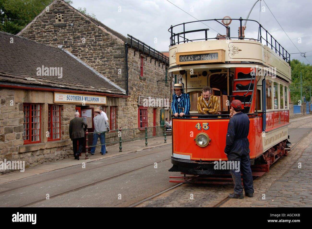 An open topped high st tram stops on the cobbled streets at Crich ...