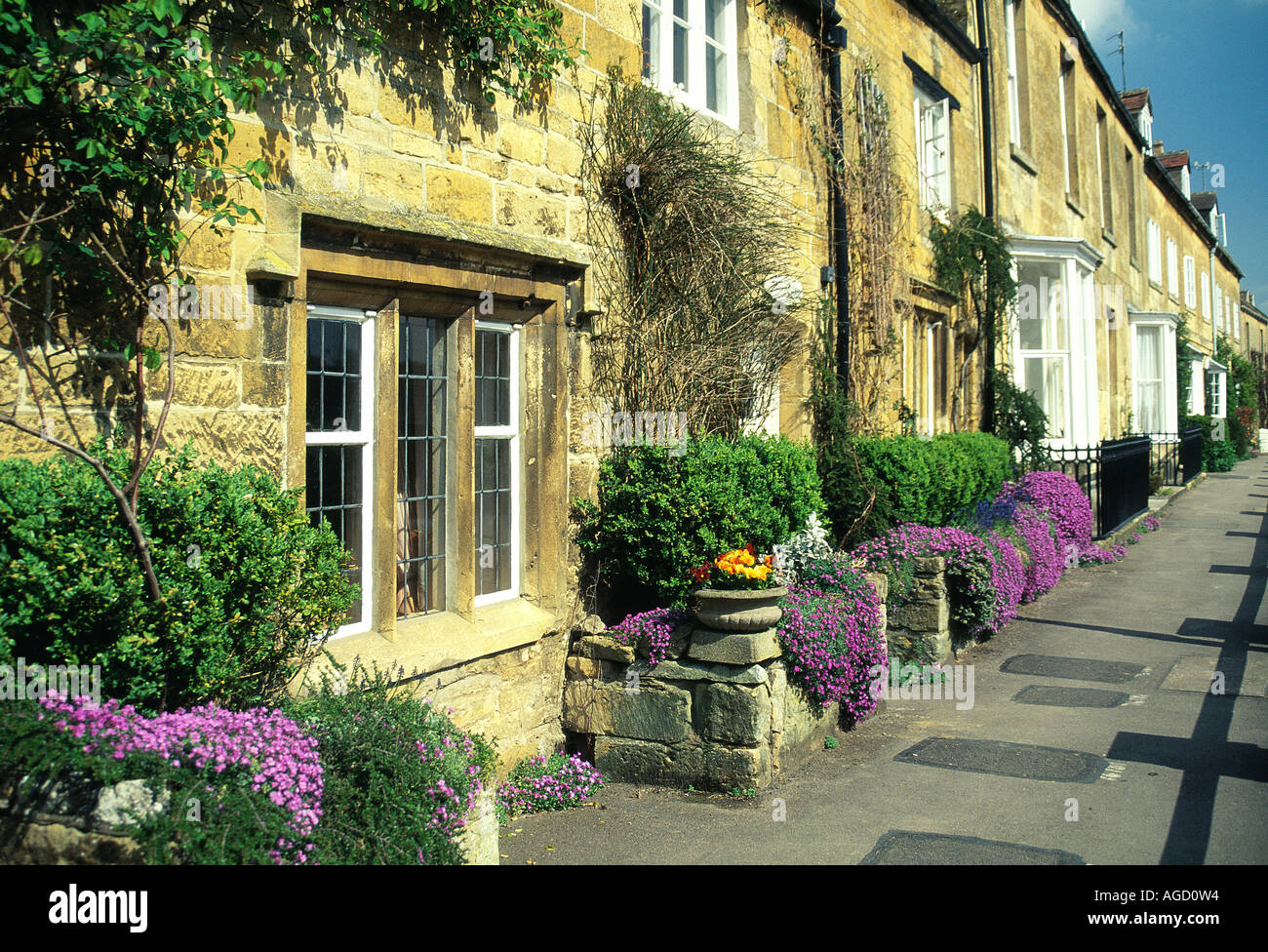 Cottages line Blockley s High Street with purple aubretia spilling out ...