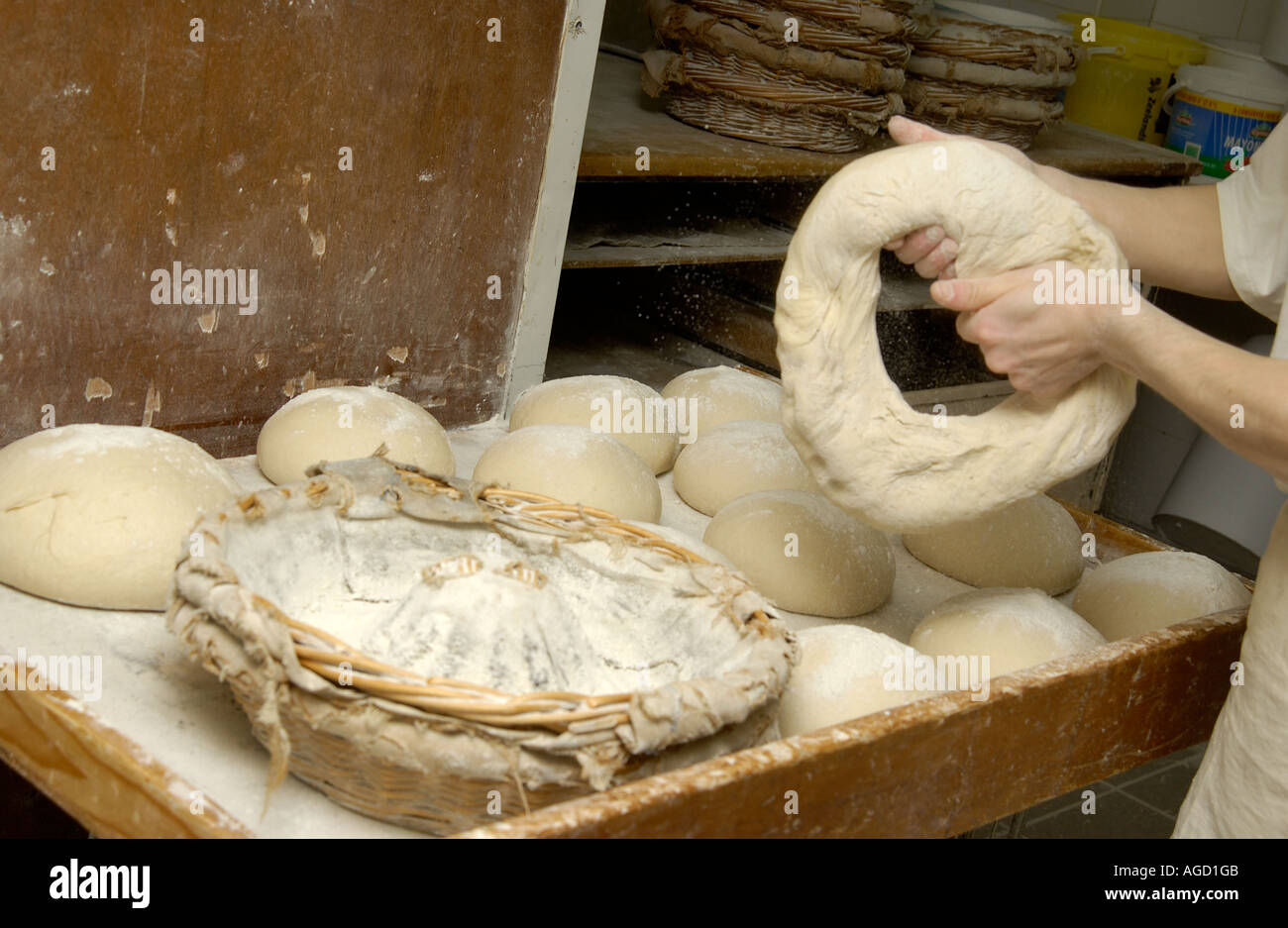 Hands skillfully shape dough into a round form in a french bakery. The ...
