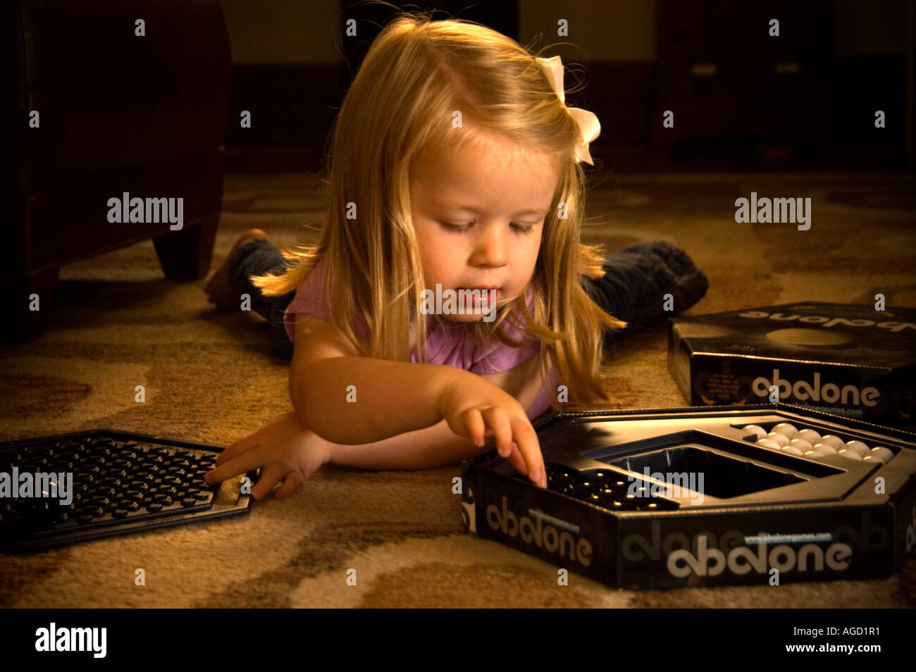 Little girl sets up a grown up game Stock Photo - Alamy