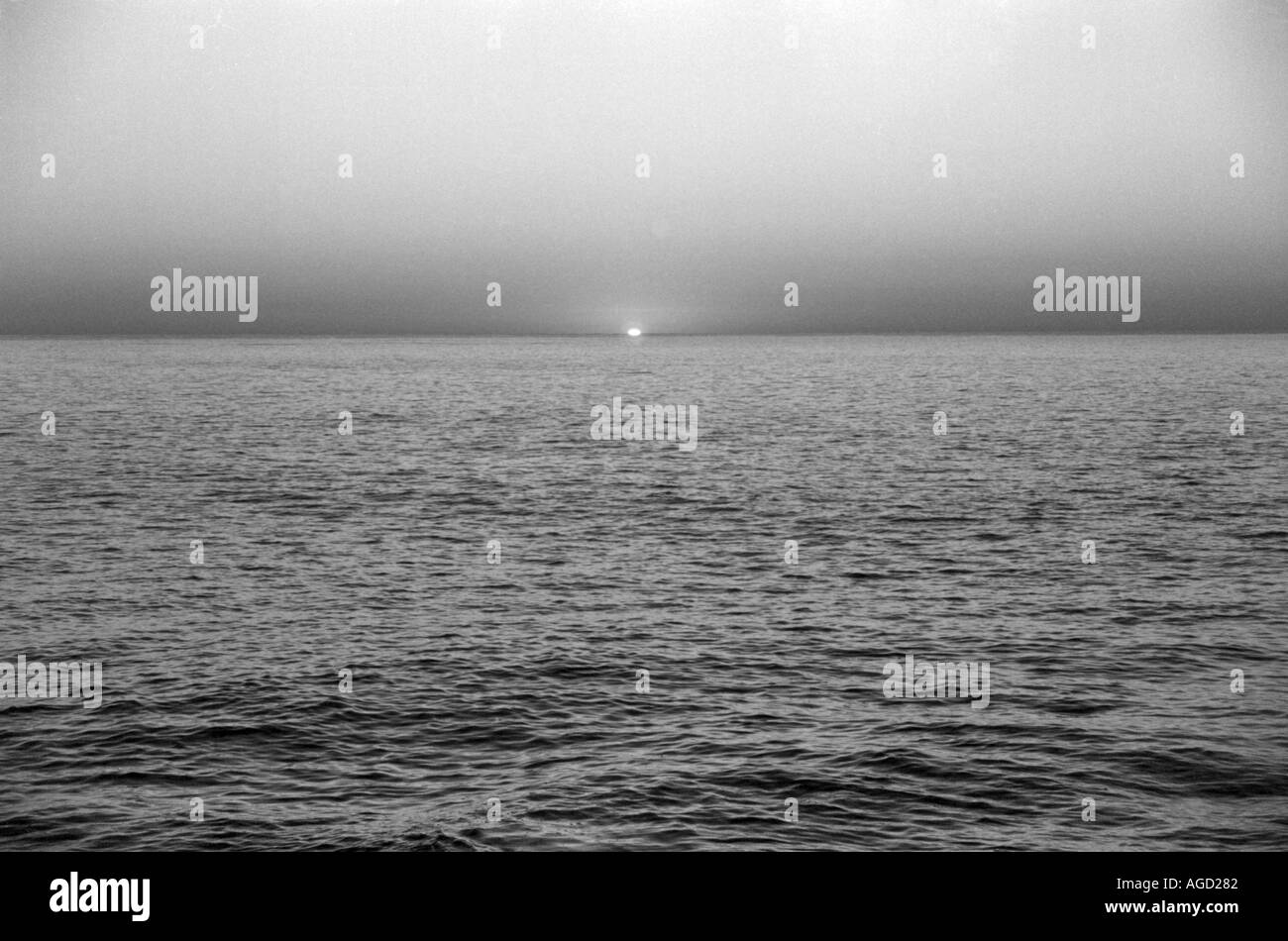Sun rise over water Black and White Stock Photos & Images - Alamy