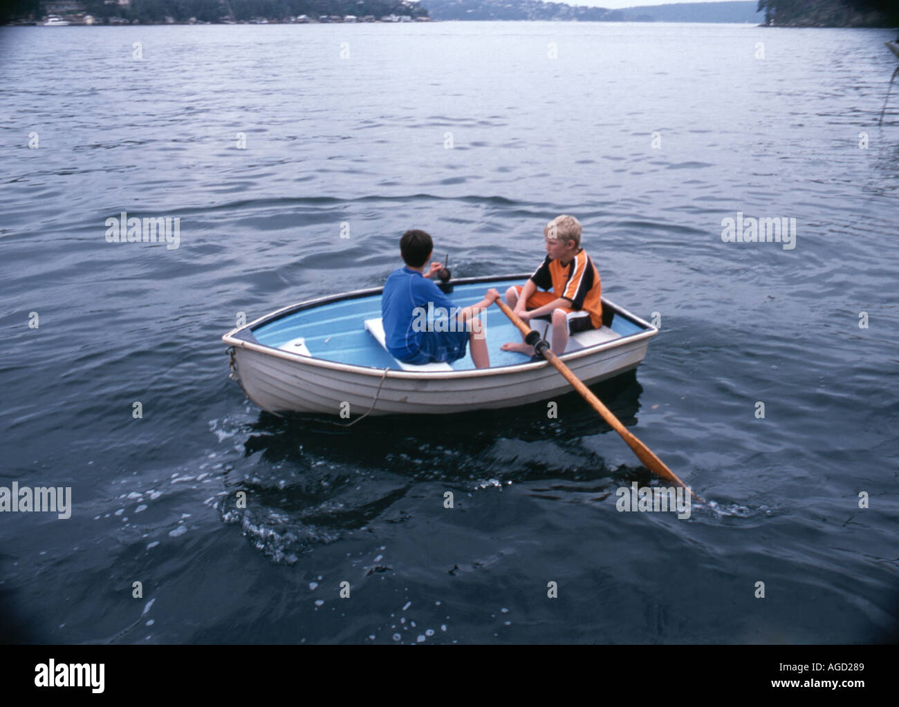 Two young boys in rowing dinghy Stock Photo - Alamy