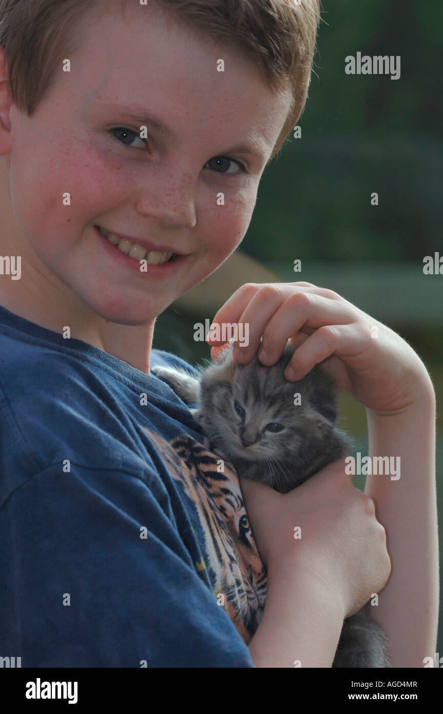 A Boy Holding A Kitten Stock Photo - Alamy