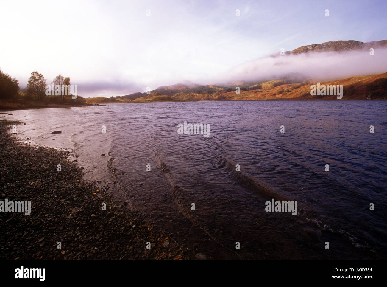 Mist over loch in scottish highlands in scotland uk Stock Photo - Alamy