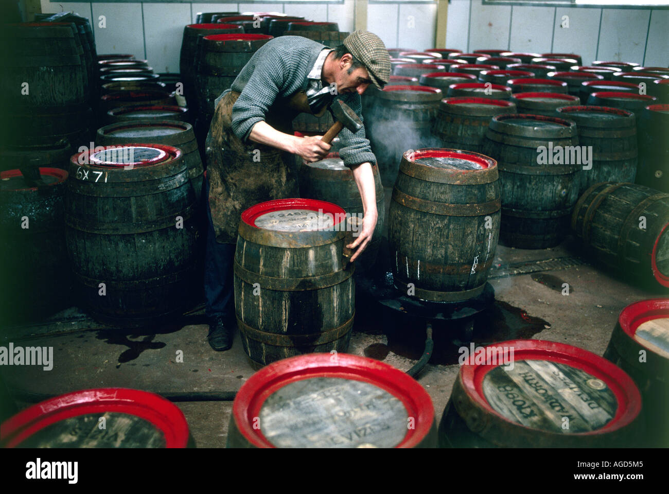 A cooper works on traditional wooden barrels in Wadworth Brewery Stock ...