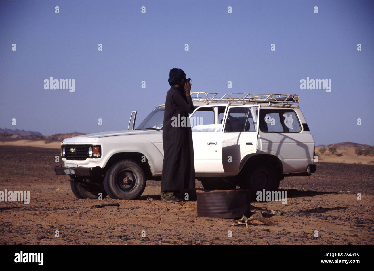 Libya beduin car jeep man standing desert waiting Sahara Berberian ...