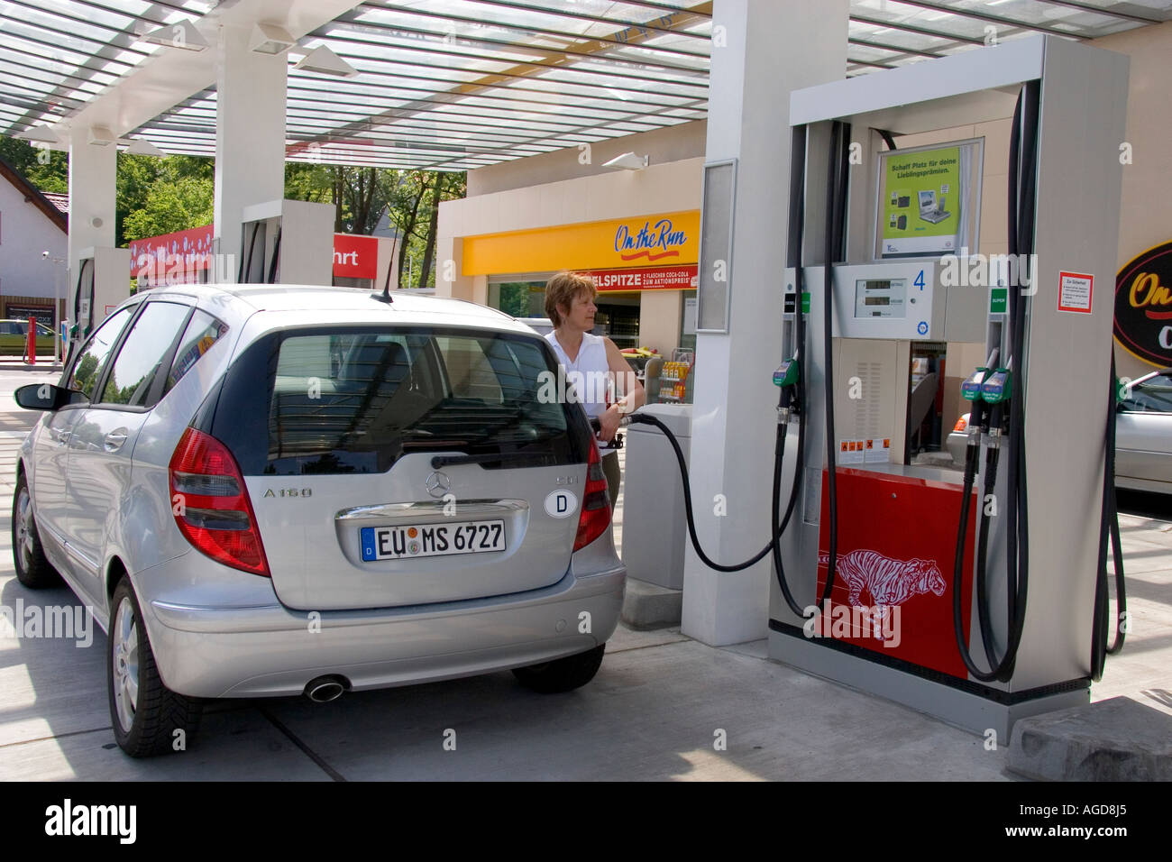 Woman fueling a car at a gas station in Friesing, Germany Stock Photo ...