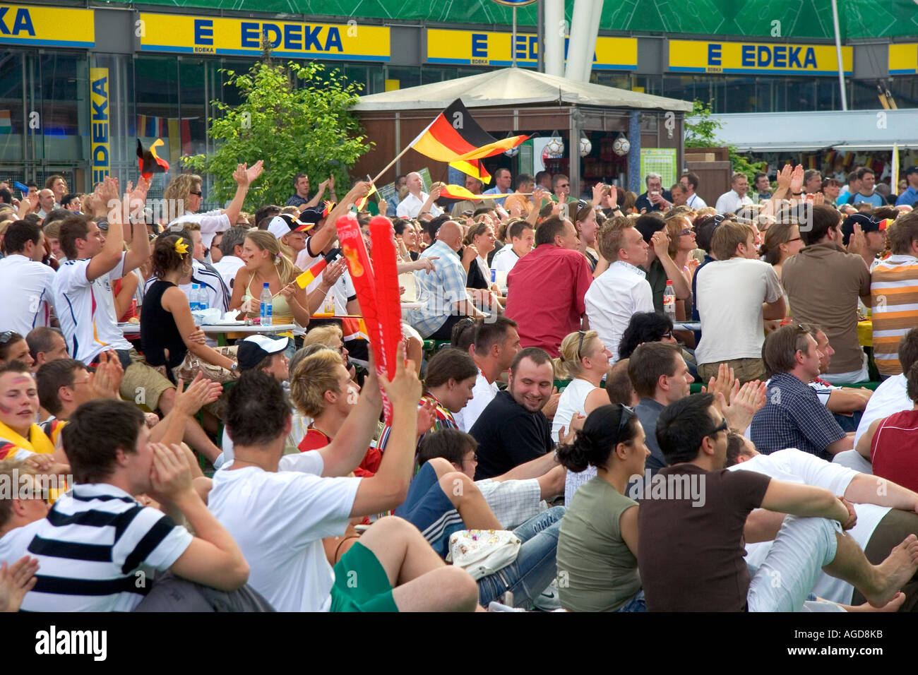 A crowd of soccer fans gather outdoors at the Munich airport watch a ...