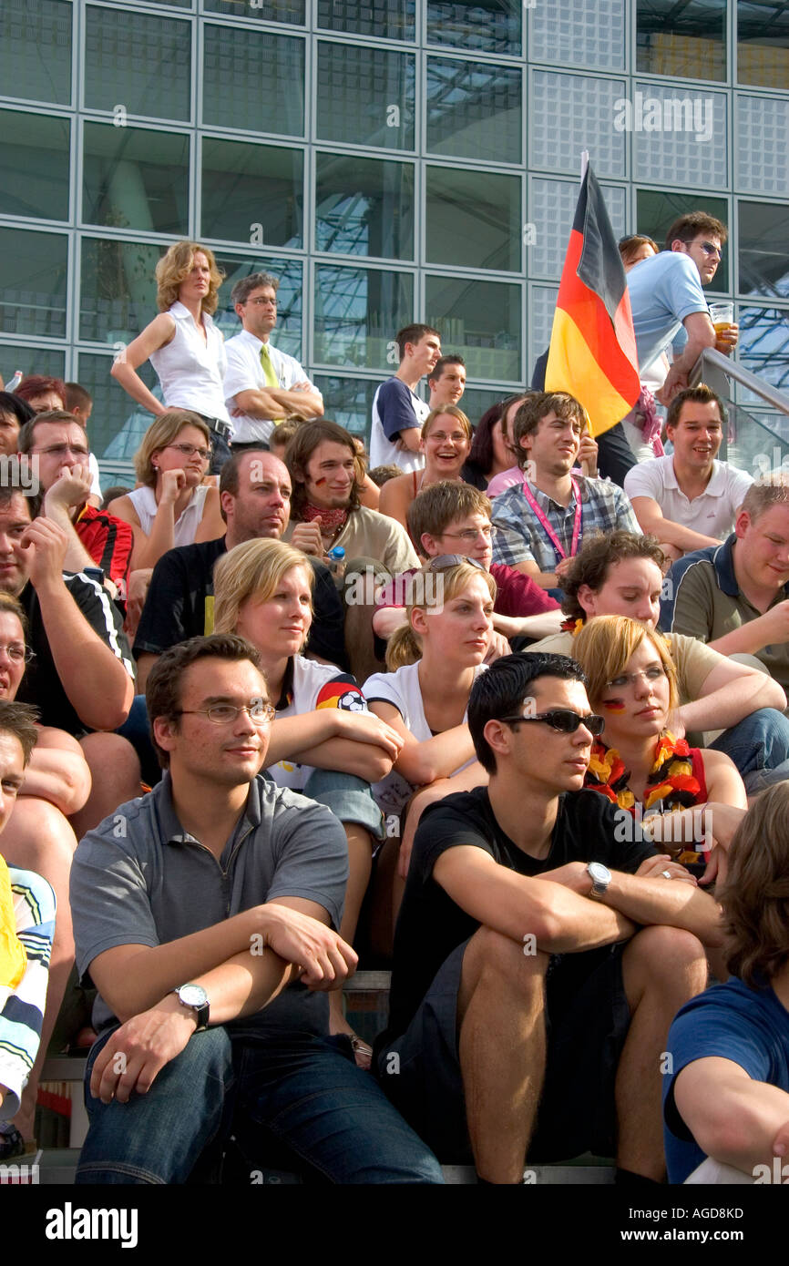 A crowd of soccer fans gather outdoors at the Munich airport watch a ...