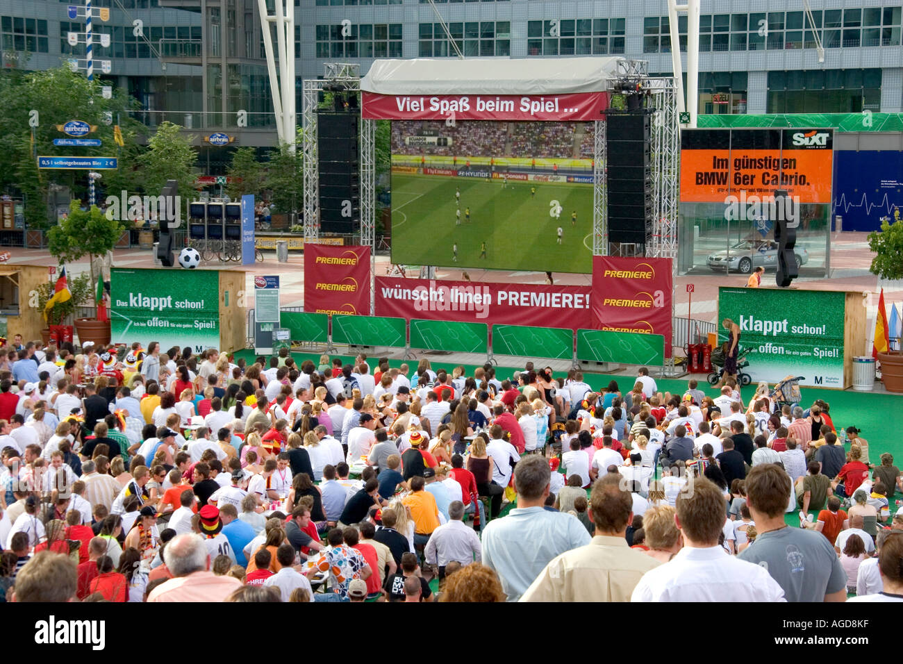 A crowd of soccer fans gather outdoors at the Munich airport watch a ...