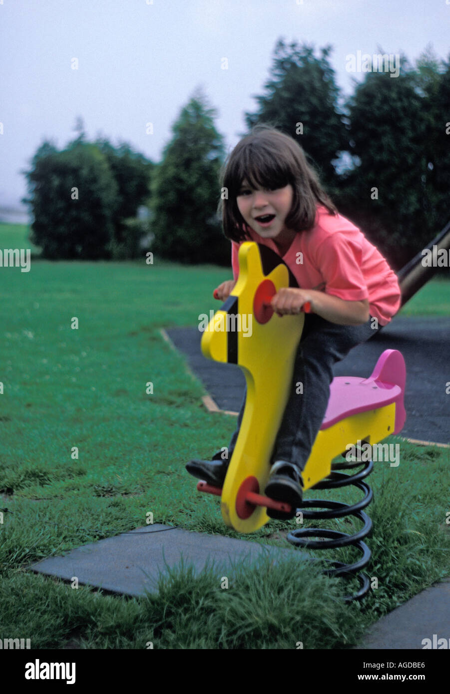 Child on playground rocking horse Stock Photo - Alamy