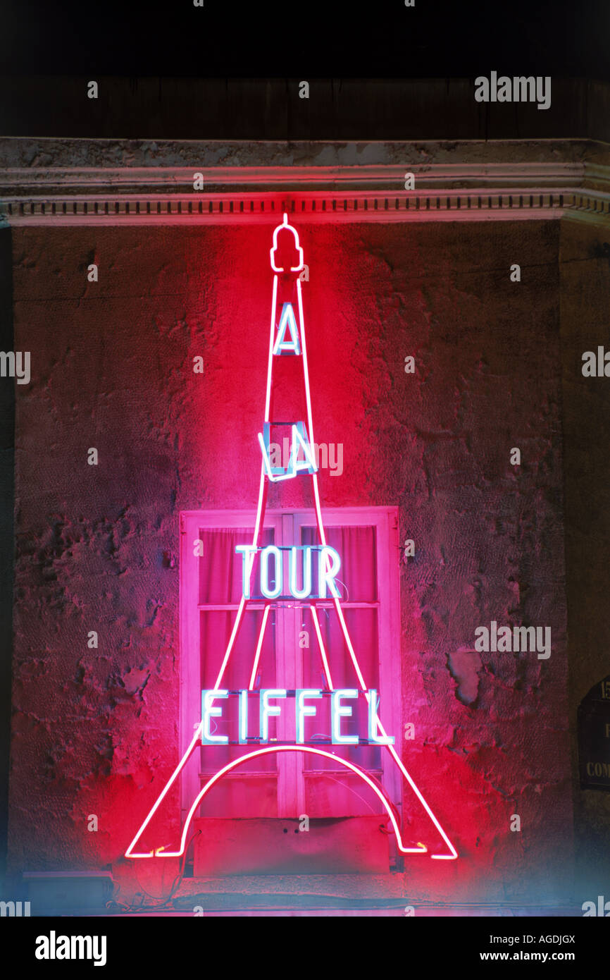 Neon light of Eiffel Tower on Paris building facade Stock Photo - Alamy