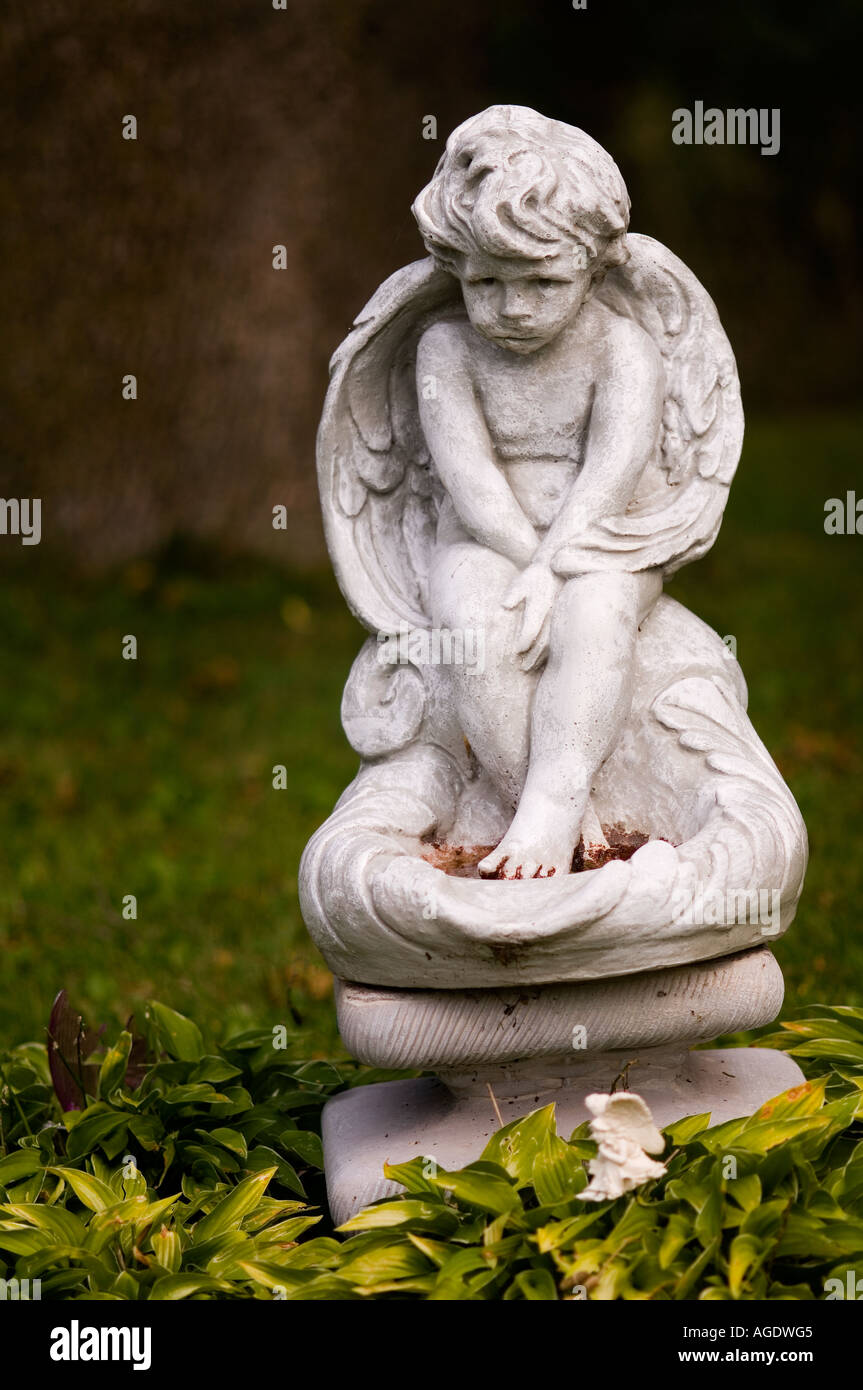 Sad cupid statue in cemetery Stock Photo - Alamy
