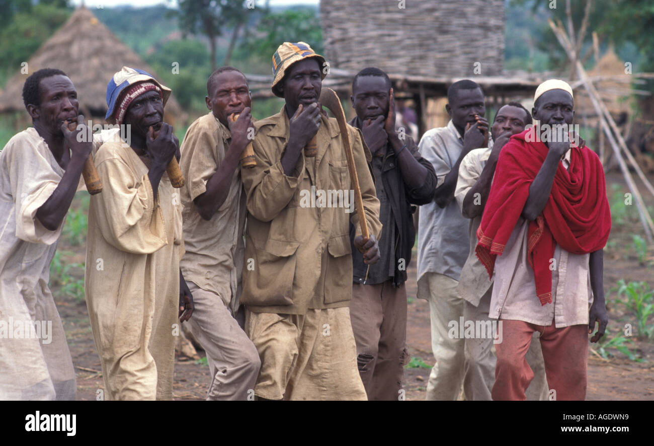 Sudanese men playing musical instruments in a refugee camp set up in ...