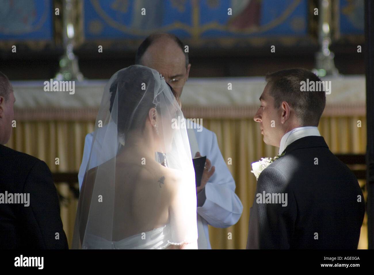 Bride & groom take their vows in English parish church Stock Photo - Alamy