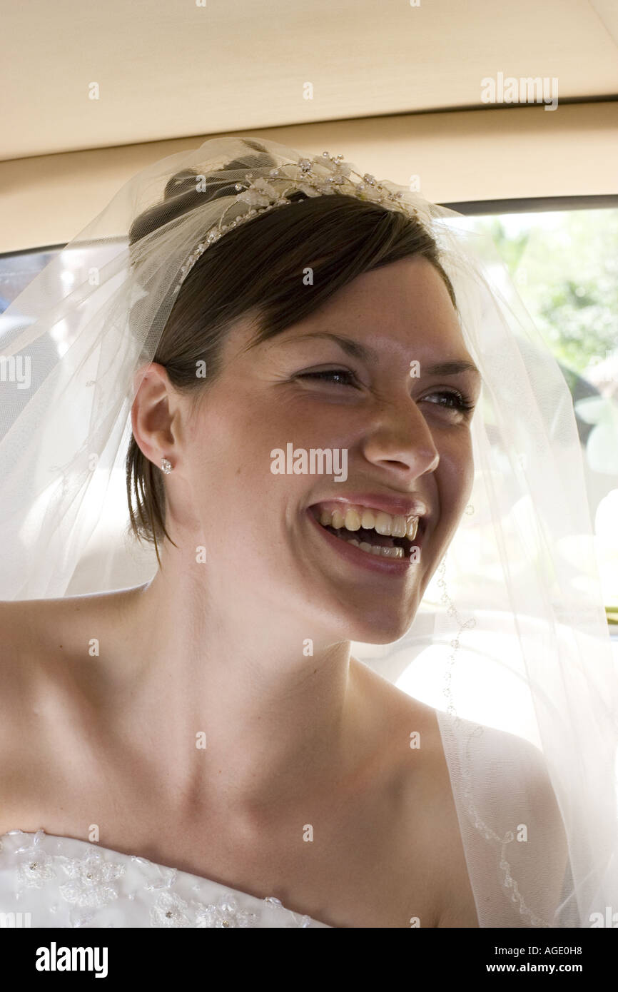 Laughing bride in wedding car Stock Photo - Alamy