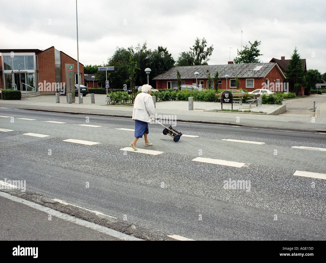 Old lady with lawn mower crossing the road Jutland Denmark Stock Photo ...