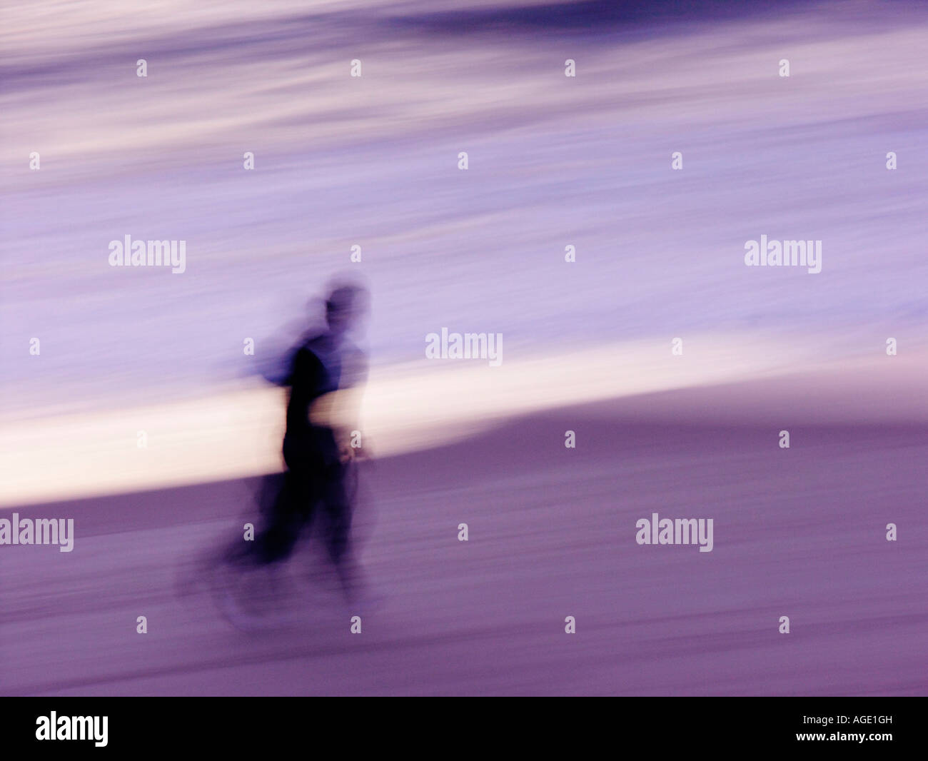 Man running on beach, motion blur Stock Photo - Alamy