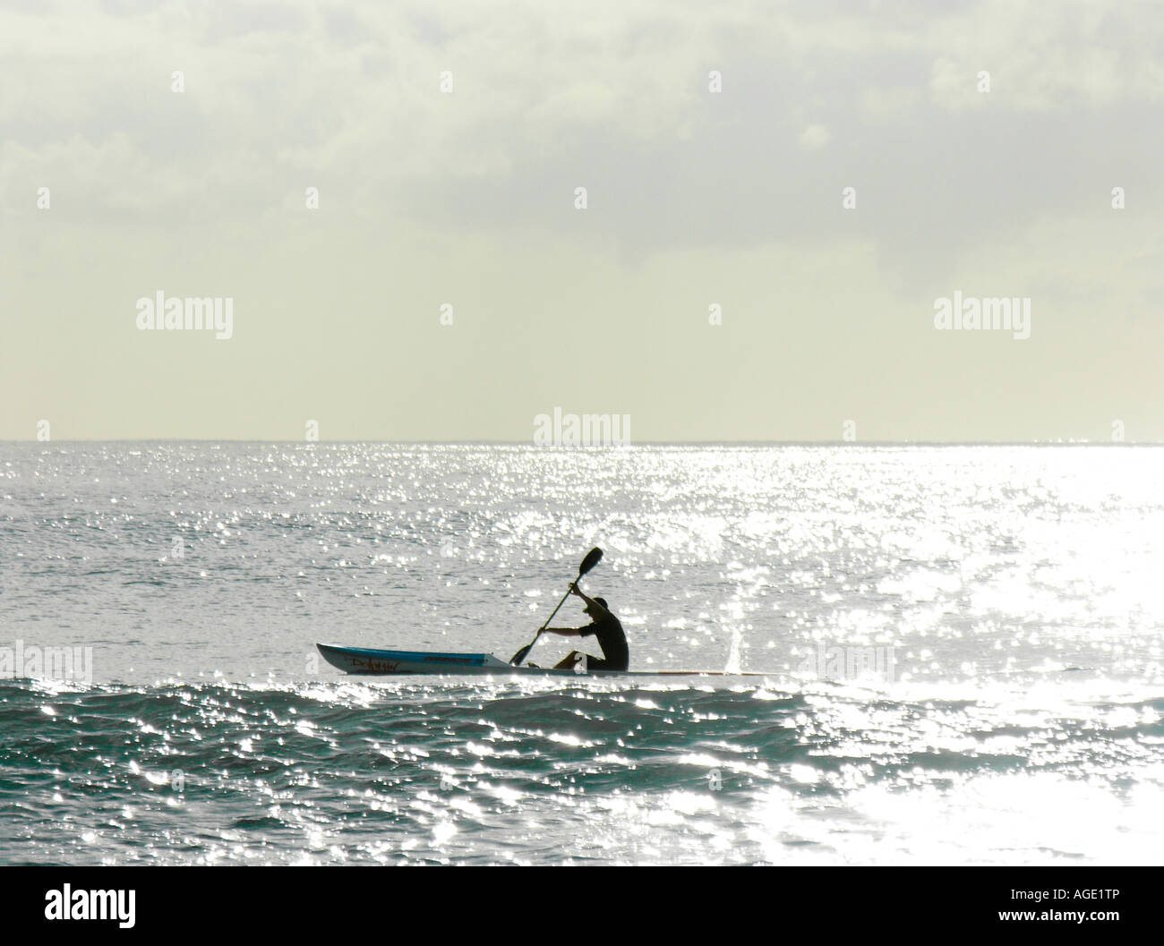 Sea kayaker in glistening sea Stock Photo - Alamy