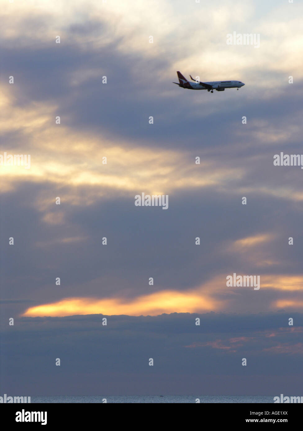 Qantas plane over sea dramatic sky, slight motion blur Stock Photo - Alamy