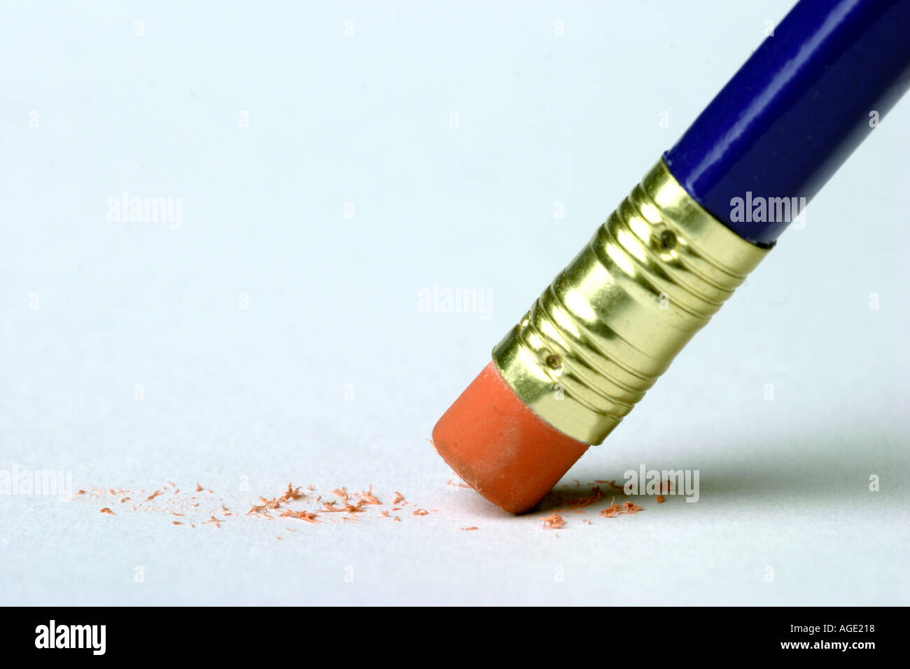 Eraser on the end of a pencil rubbing out on a white sheet of paper ...
