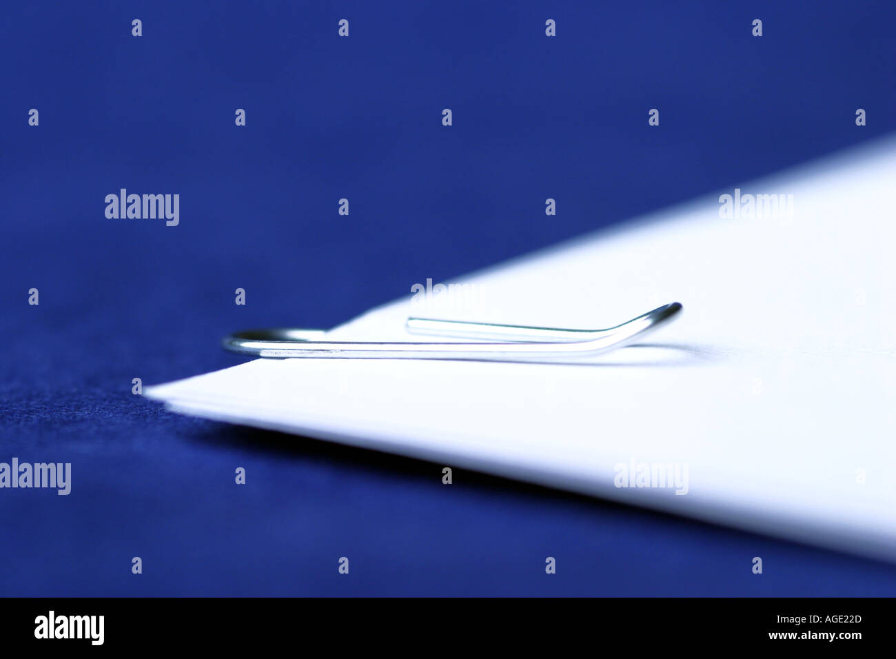 Paperclip holding sheets of paper together Stock Photo - Alamy