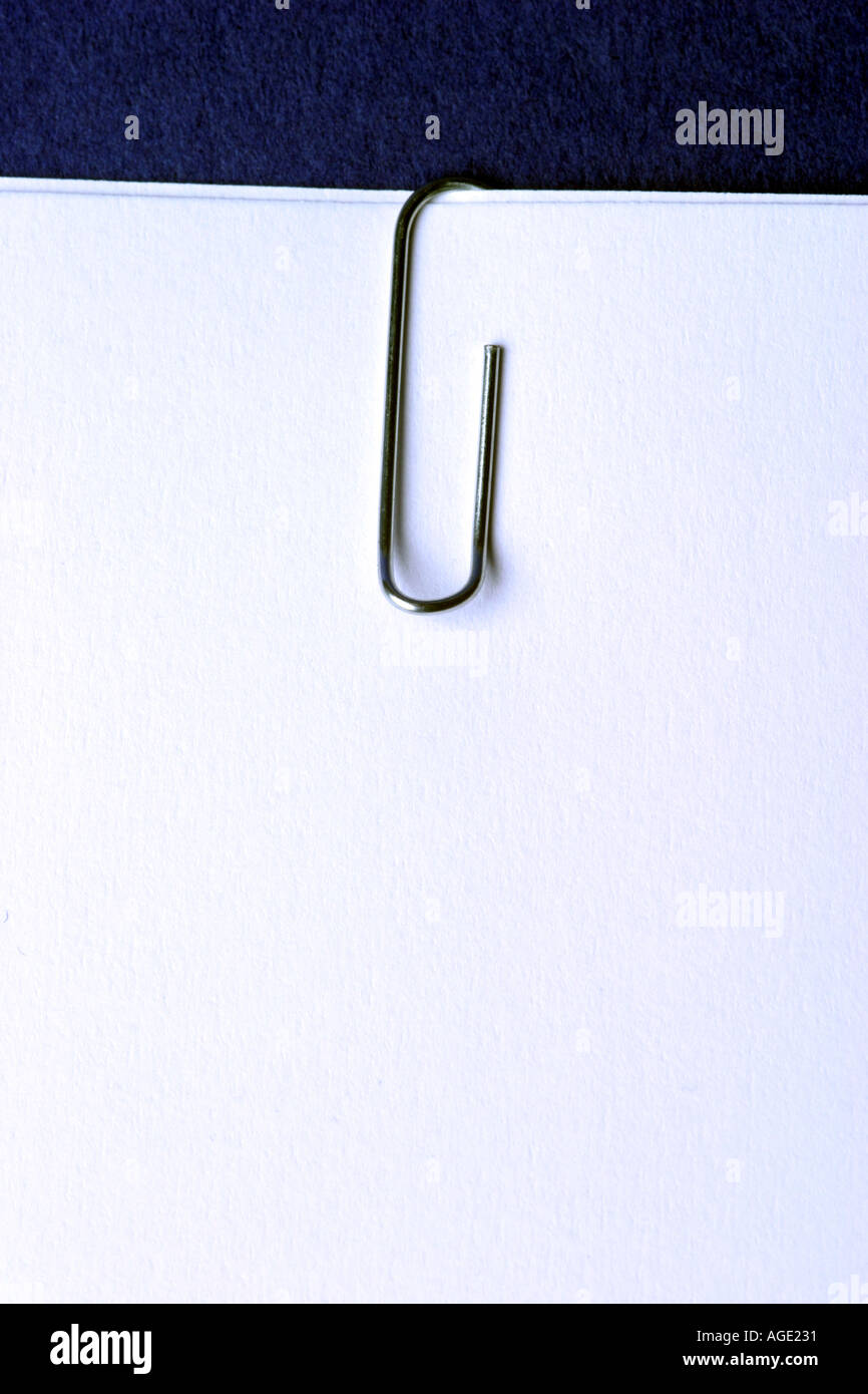 Paperclip holding sheets of paper together Stock Photo - Alamy