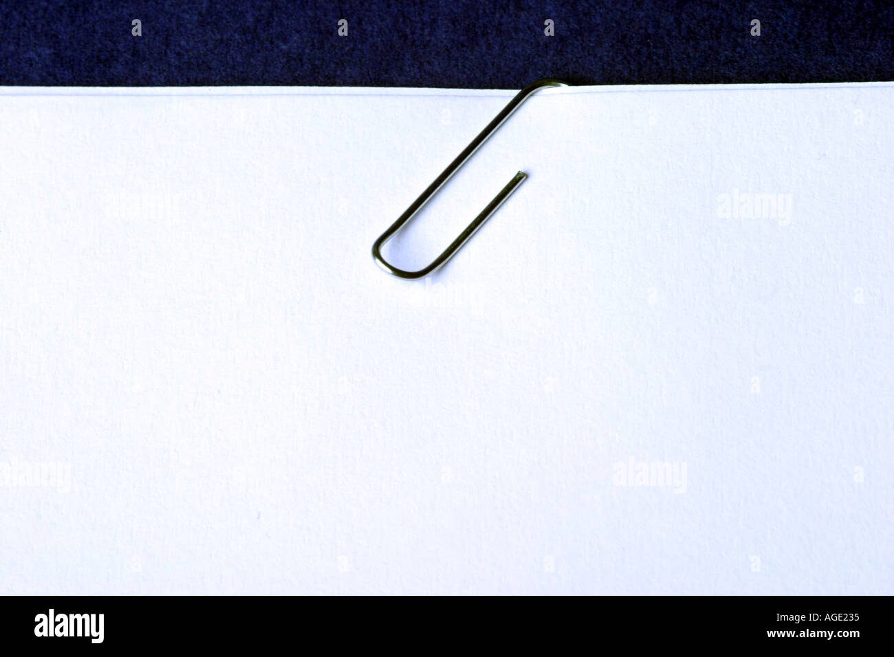 Paperclip holding sheets of paper together Stock Photo - Alamy