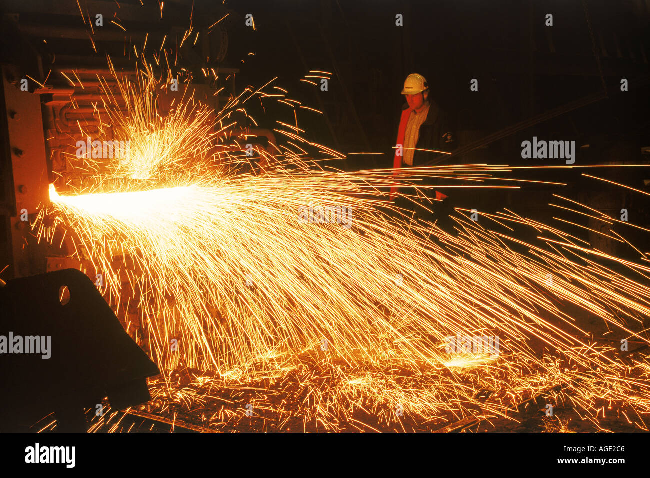 Steel Mill Sparks Steelworkers Standing Near A Blast Furnace With