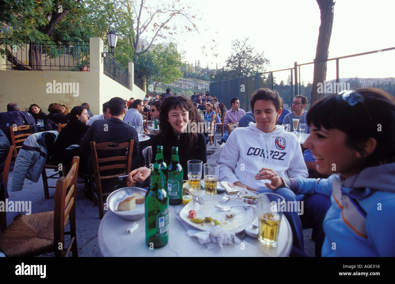 Greece Athens Young people sitting at an outdoors taverna plaka area ...