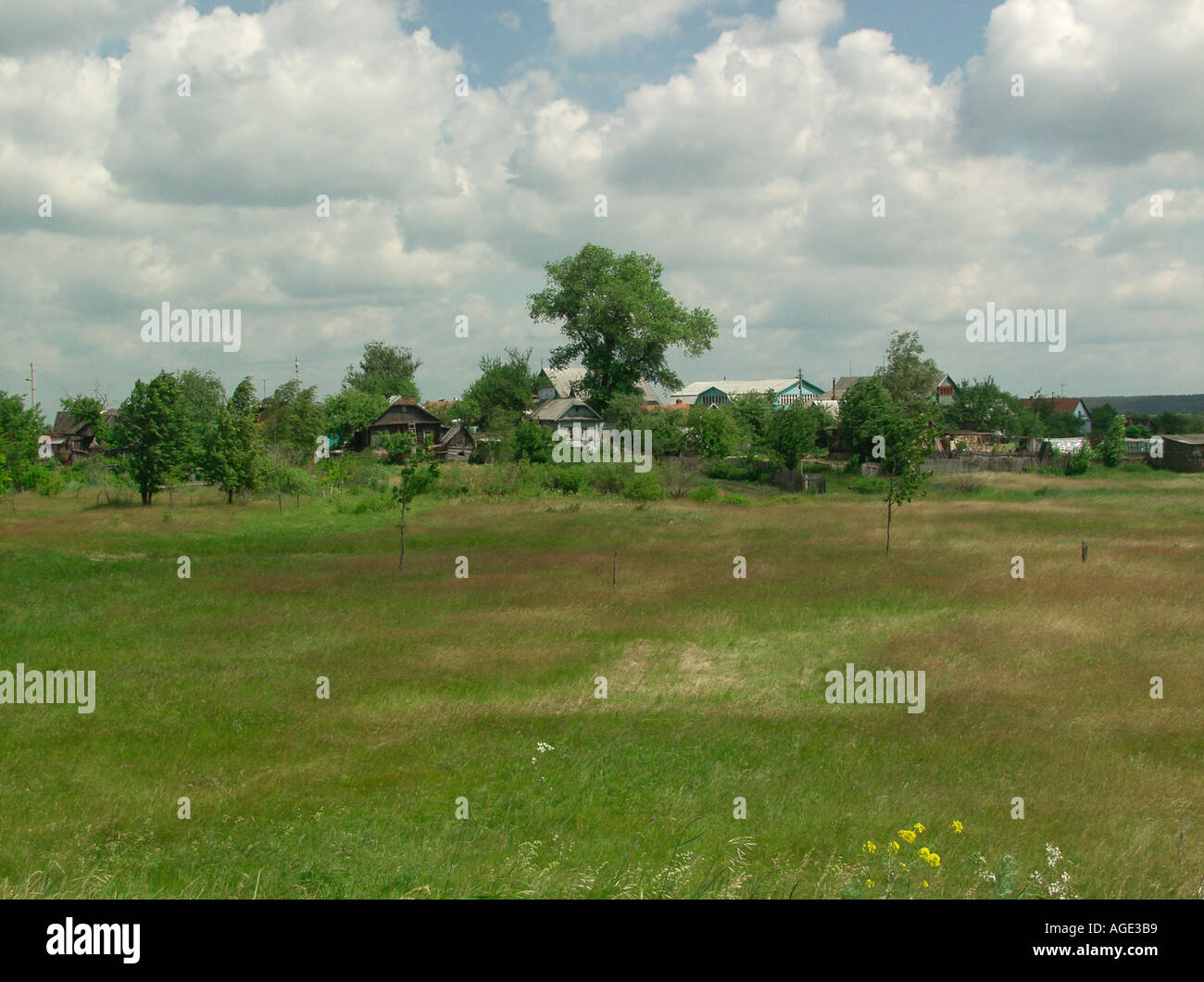Nimbus clouds over Belarussian landscape with small village containing ...