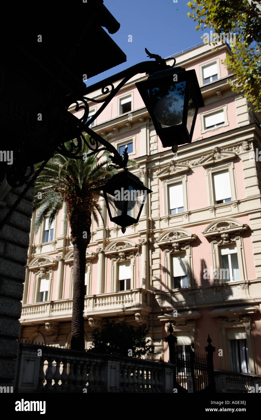Pink Umbertine Palace building in Rome with old gas lamps from early ...