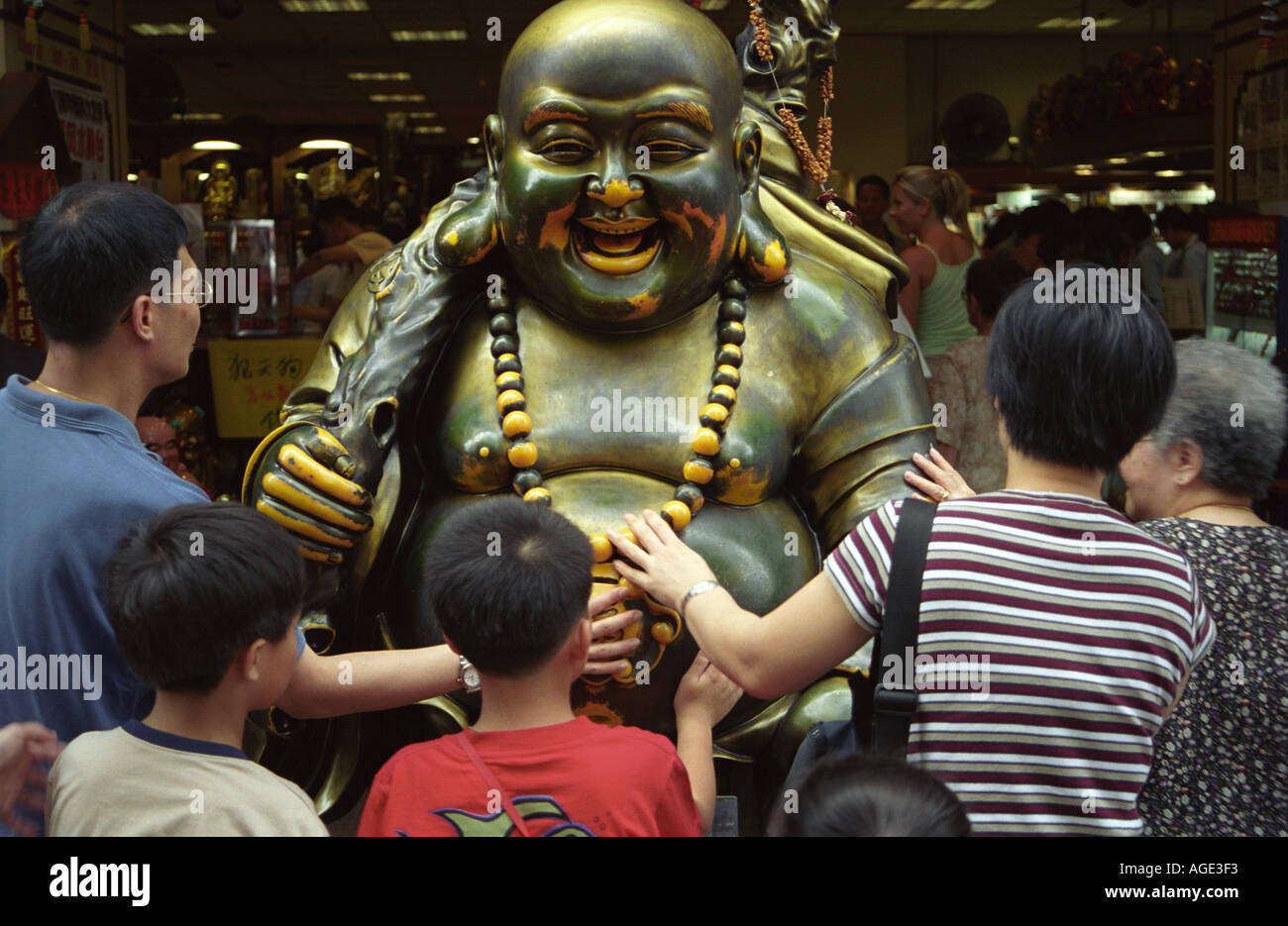 People touching Golden Buddah for good luck in Singapore Stock Photo ...