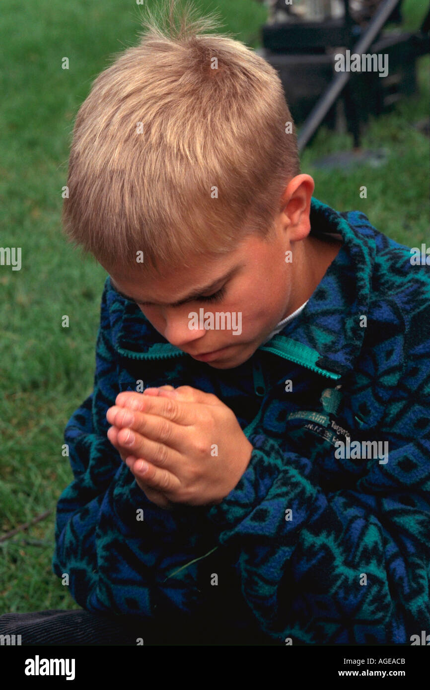 Young boy praying outside age 7. St Paul Minnesota USA Stock Photo - Alamy