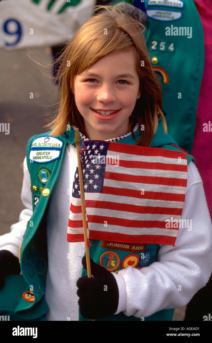 Girl scout age 10 holding the American flag at the Anoka Halloween ...