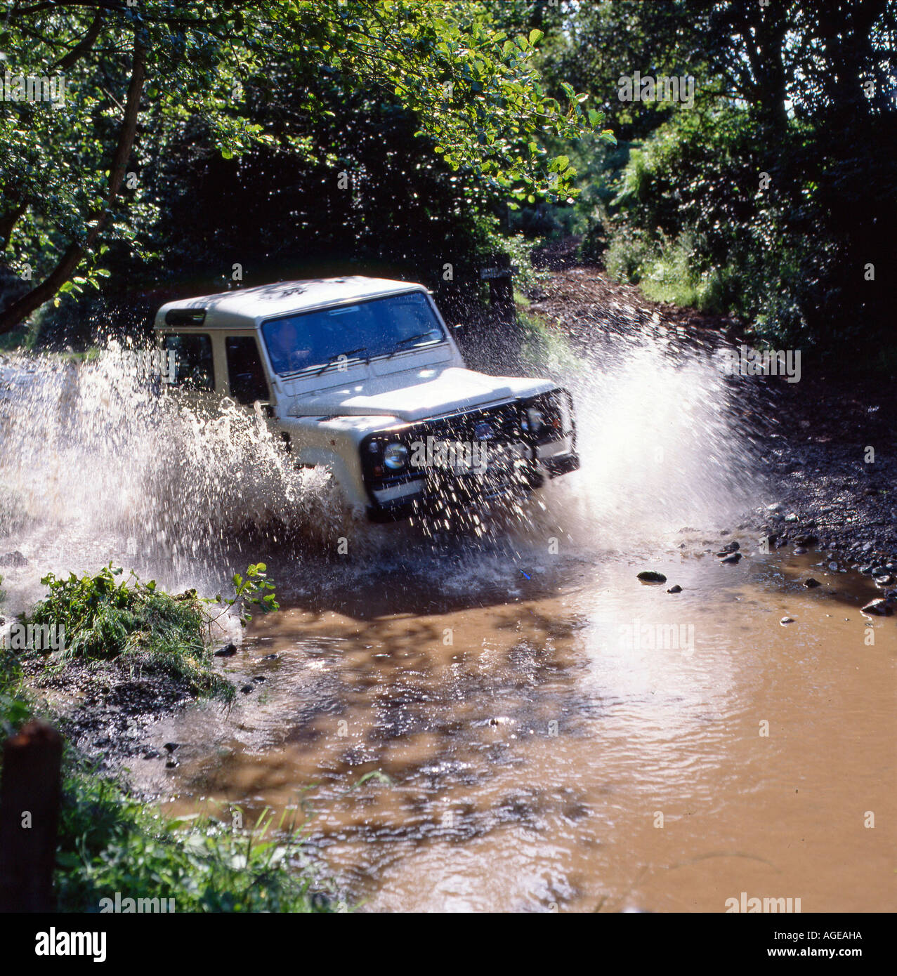 Land Rover 4 x 4 splashing through a ford (water Stock Photo - Alamy