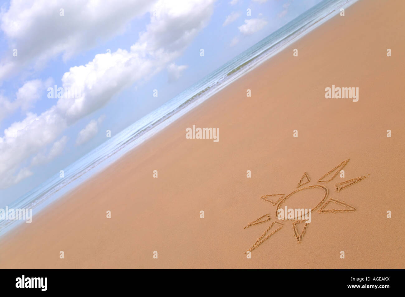 Sun drawing in the sand on a beautiful golden beach Stock Photo - Alamy